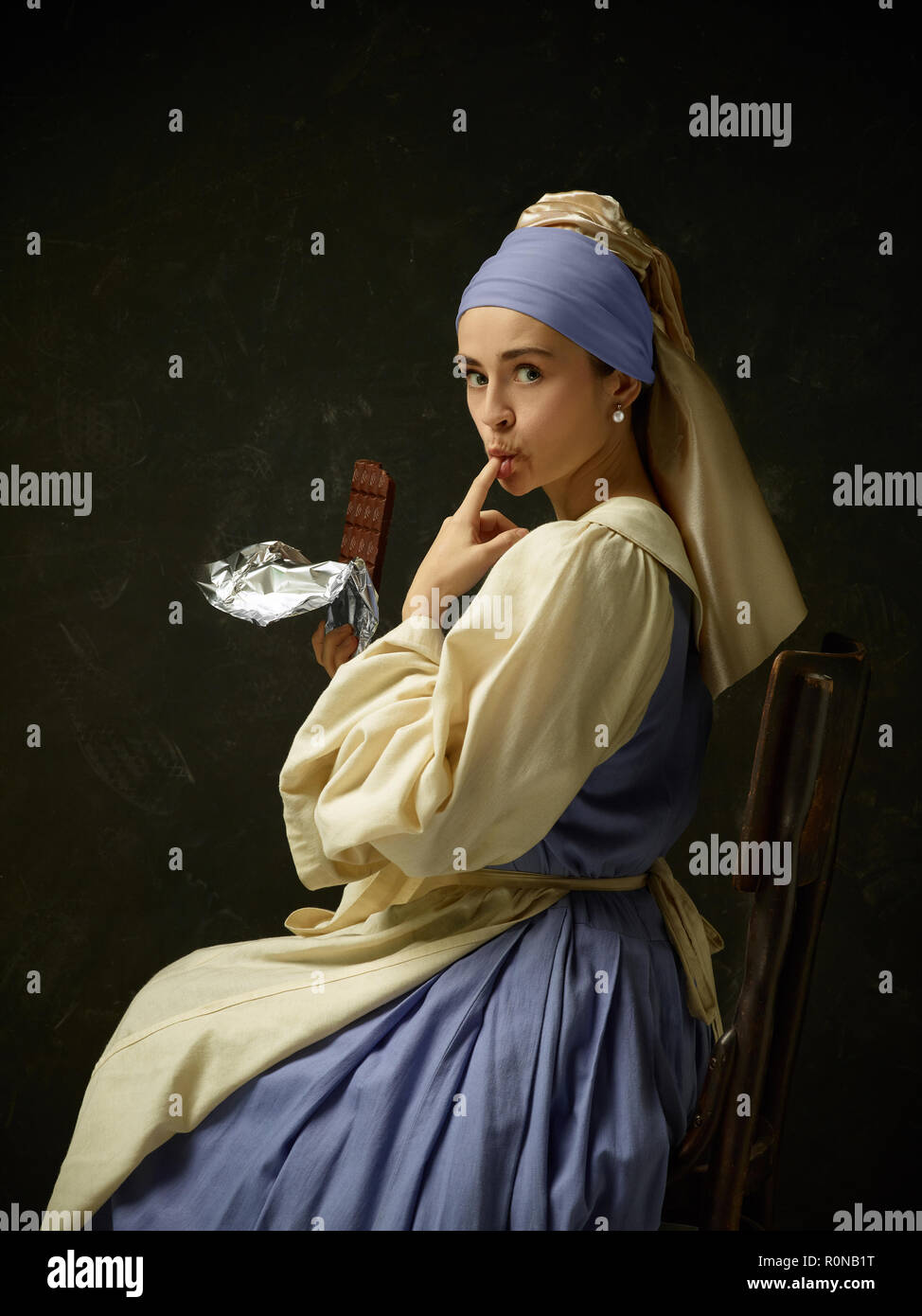 Medieval woman in historical costume wearing corset dress and bonnet ...