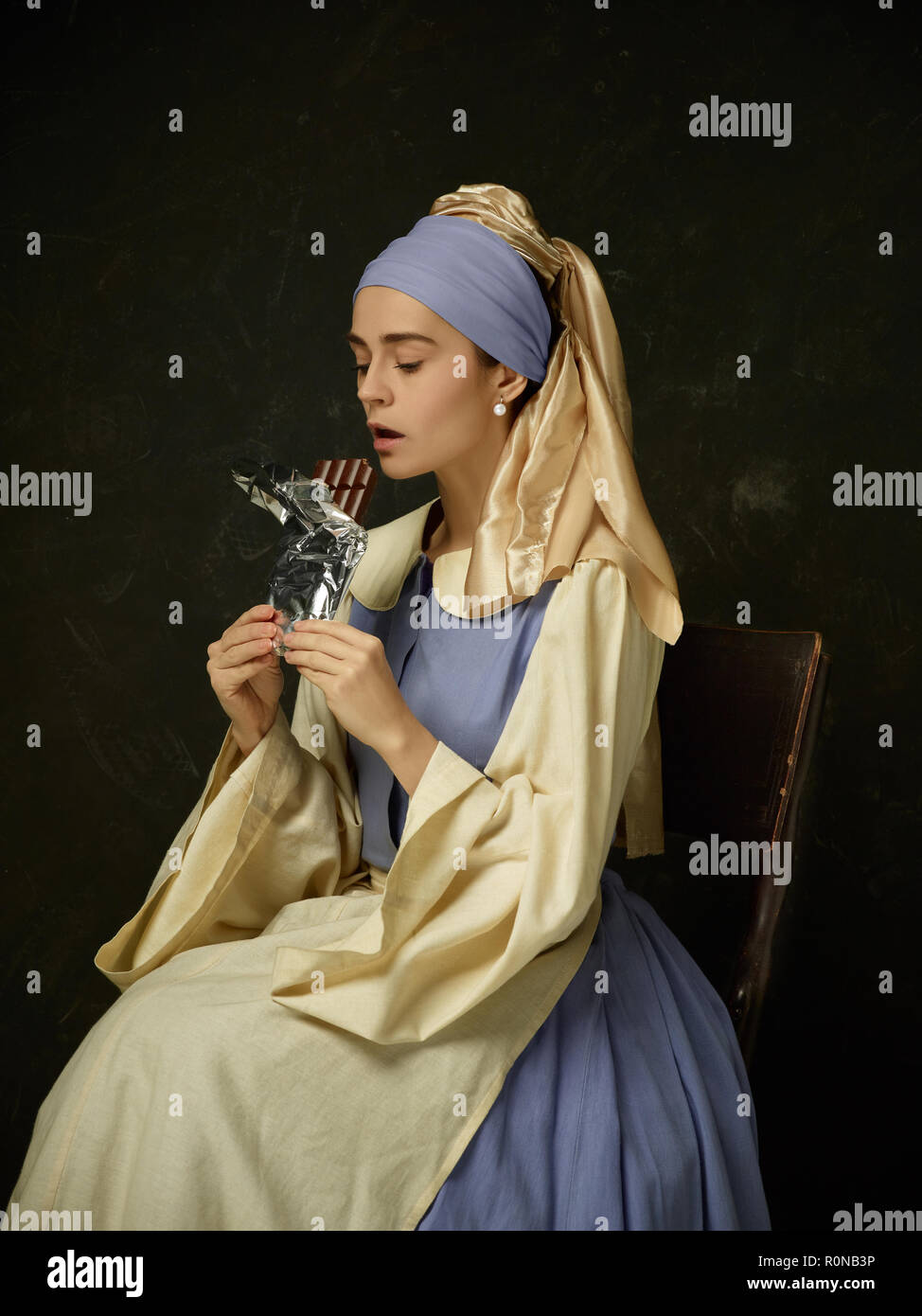 Medieval woman in historical costume wearing corset dress and bonnet ...
