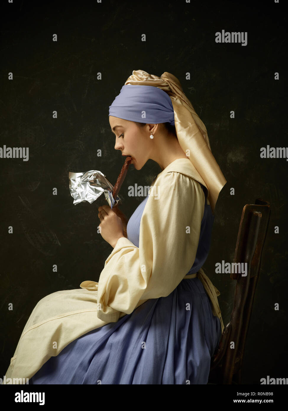 Medieval woman in historical costume wearing corset dress and bonnet ...