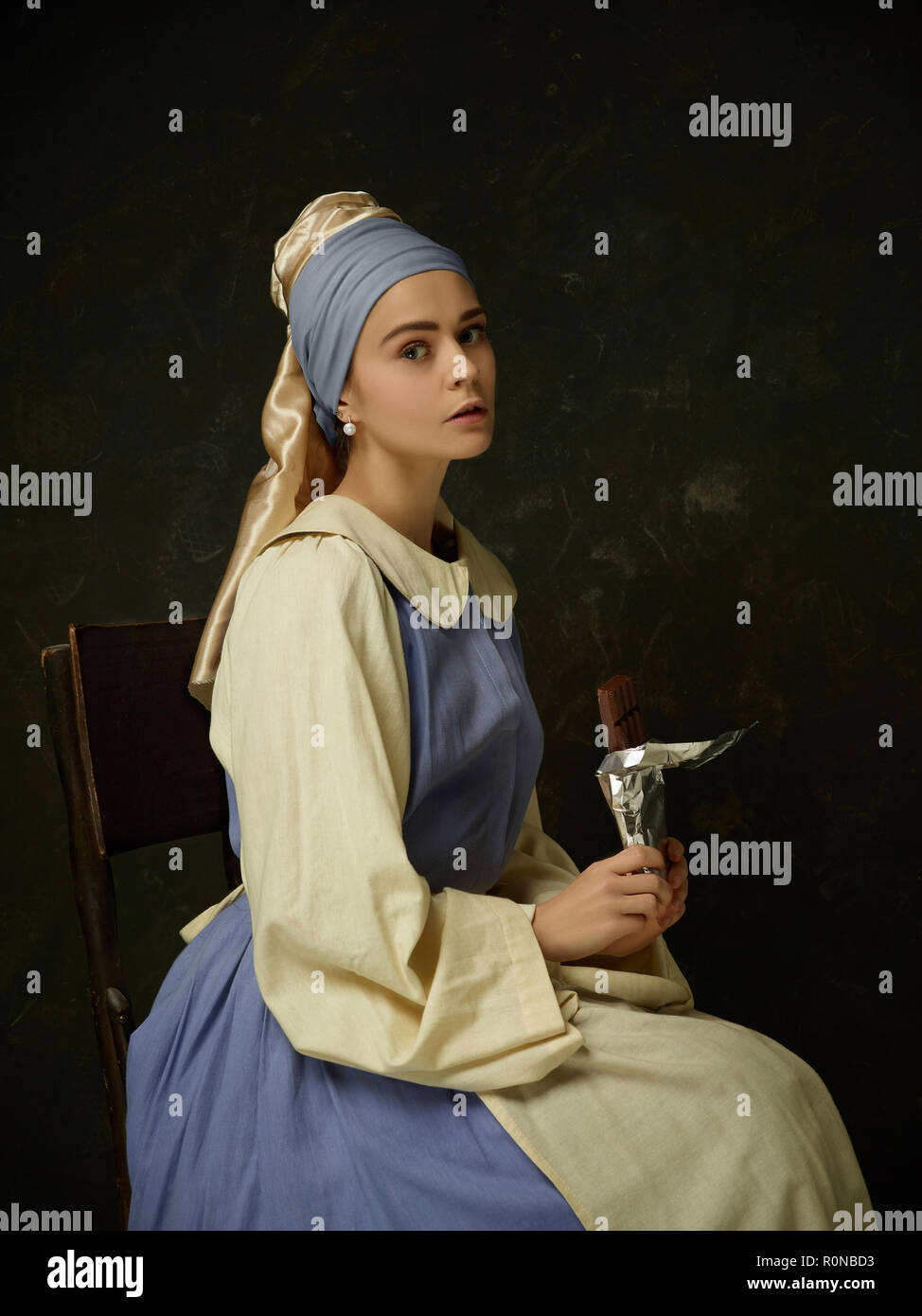 Medieval woman in historical costume wearing corset dress and bonnet ...