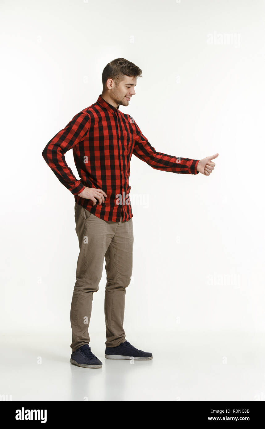 Happy business man standing and smiling isolated on studio background ...