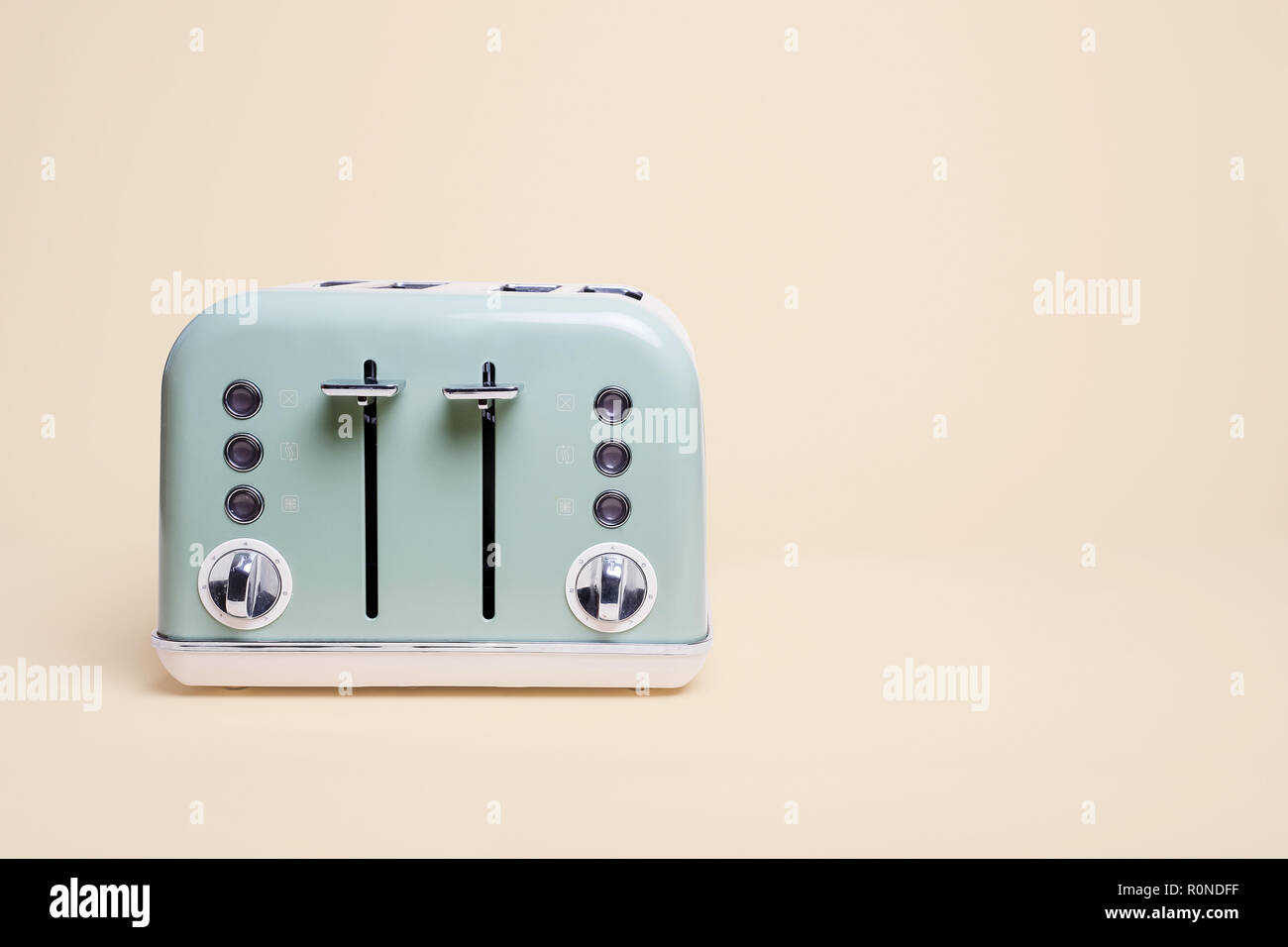 Retro green four slice double toaster that is empty on a vintage tan ...