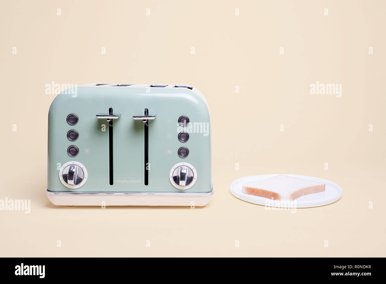 Retro green four slice double toaster on a vintage tan background with ...