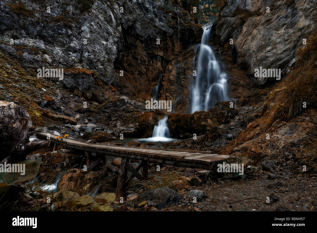 Wooden bridge to a waterfall Stock Photo - Alamy