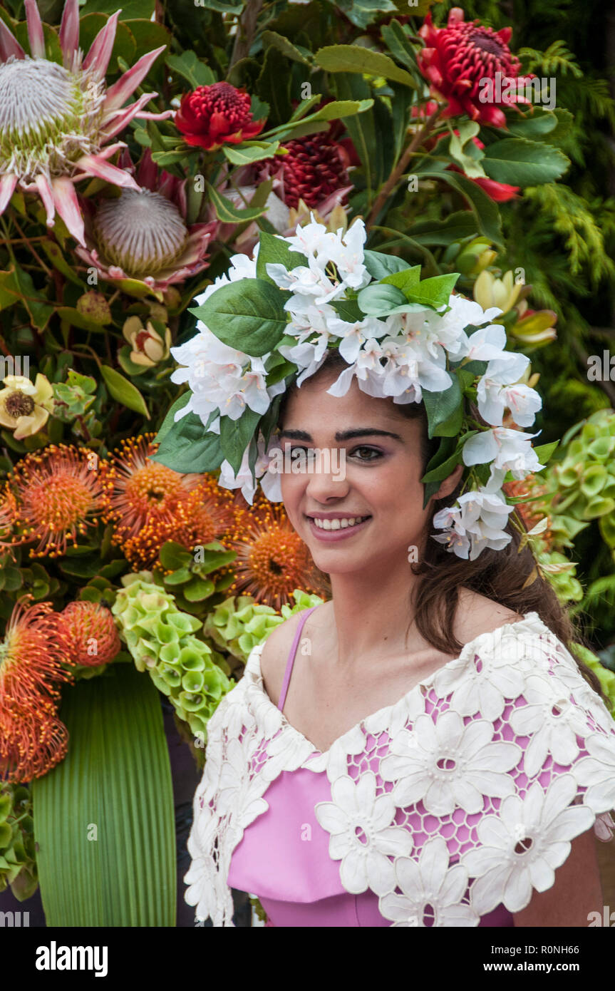 Attractive young lady wearing colourful flowery hat during a Madeira ...
