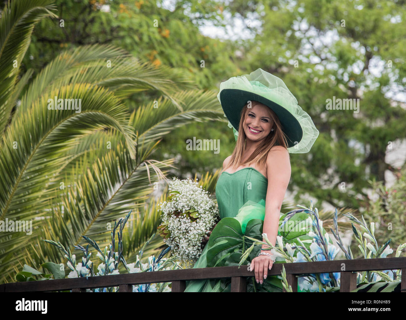 Attractive young lady wearing colourful flowery hat during a Madeira ...