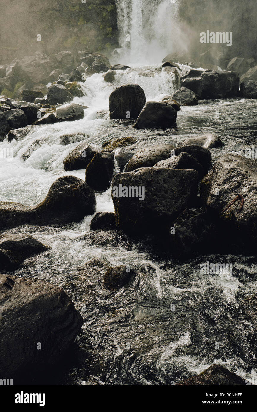 A waterfall onto rocks landscape nature background Stock Photo - Alamy