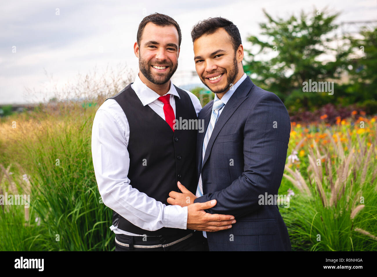 Handsome gay male couple in the park on their wedding day Stock Photo ...