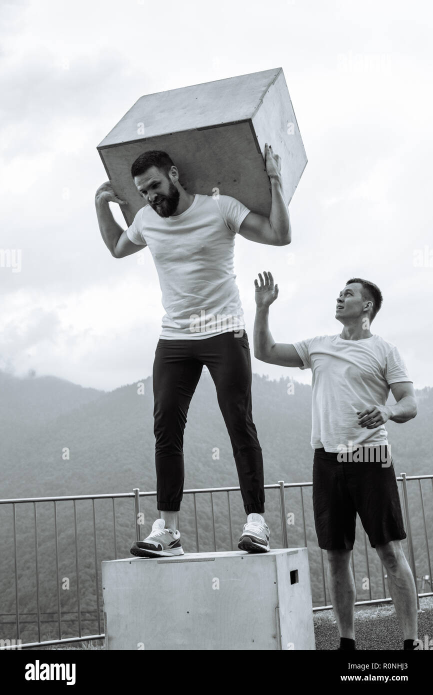 Crossfit man doing squats with weight over mountain nature background ...
