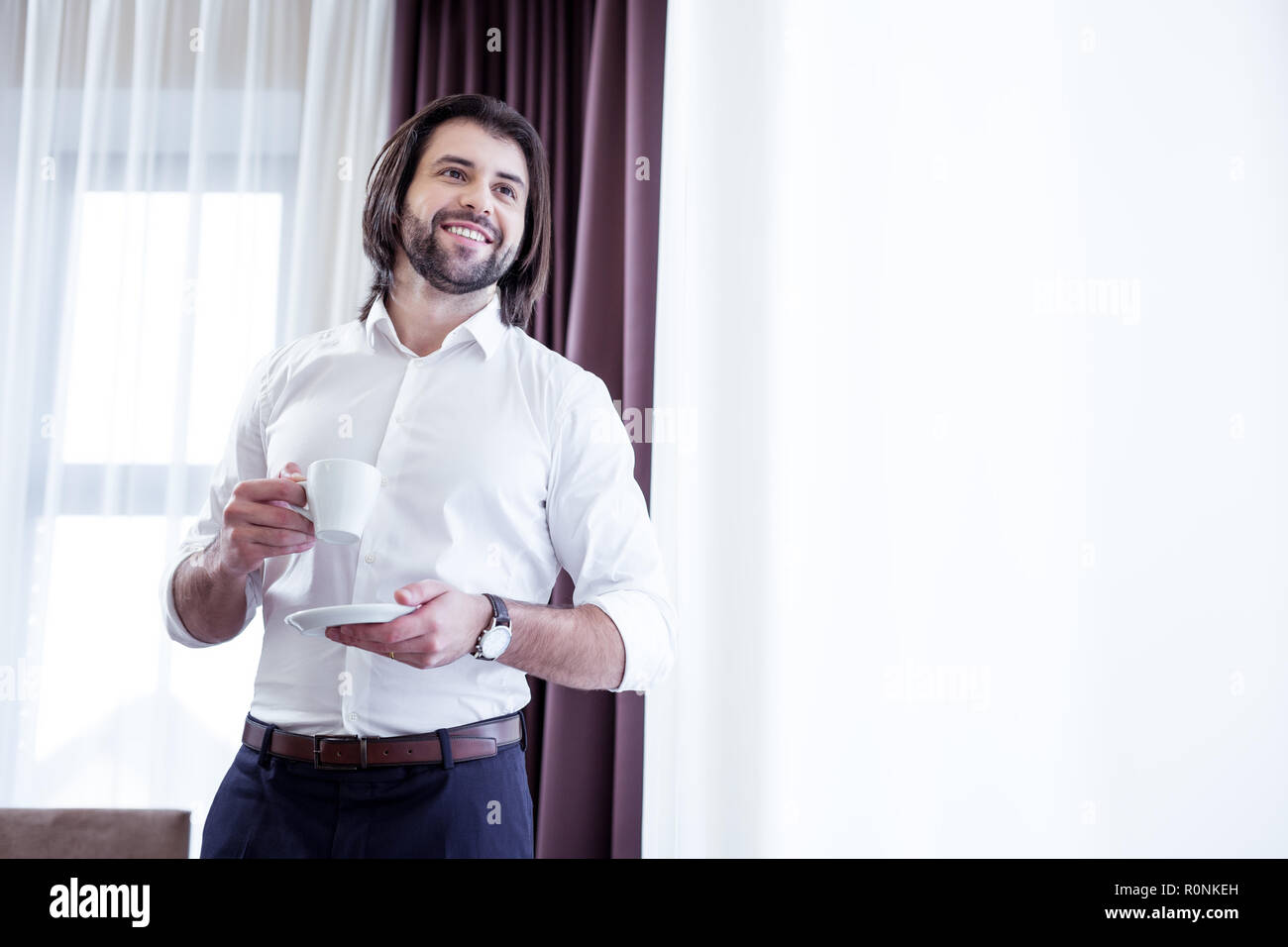 Positive happy man enjoying his delicious coffee Stock Photo - Alamy