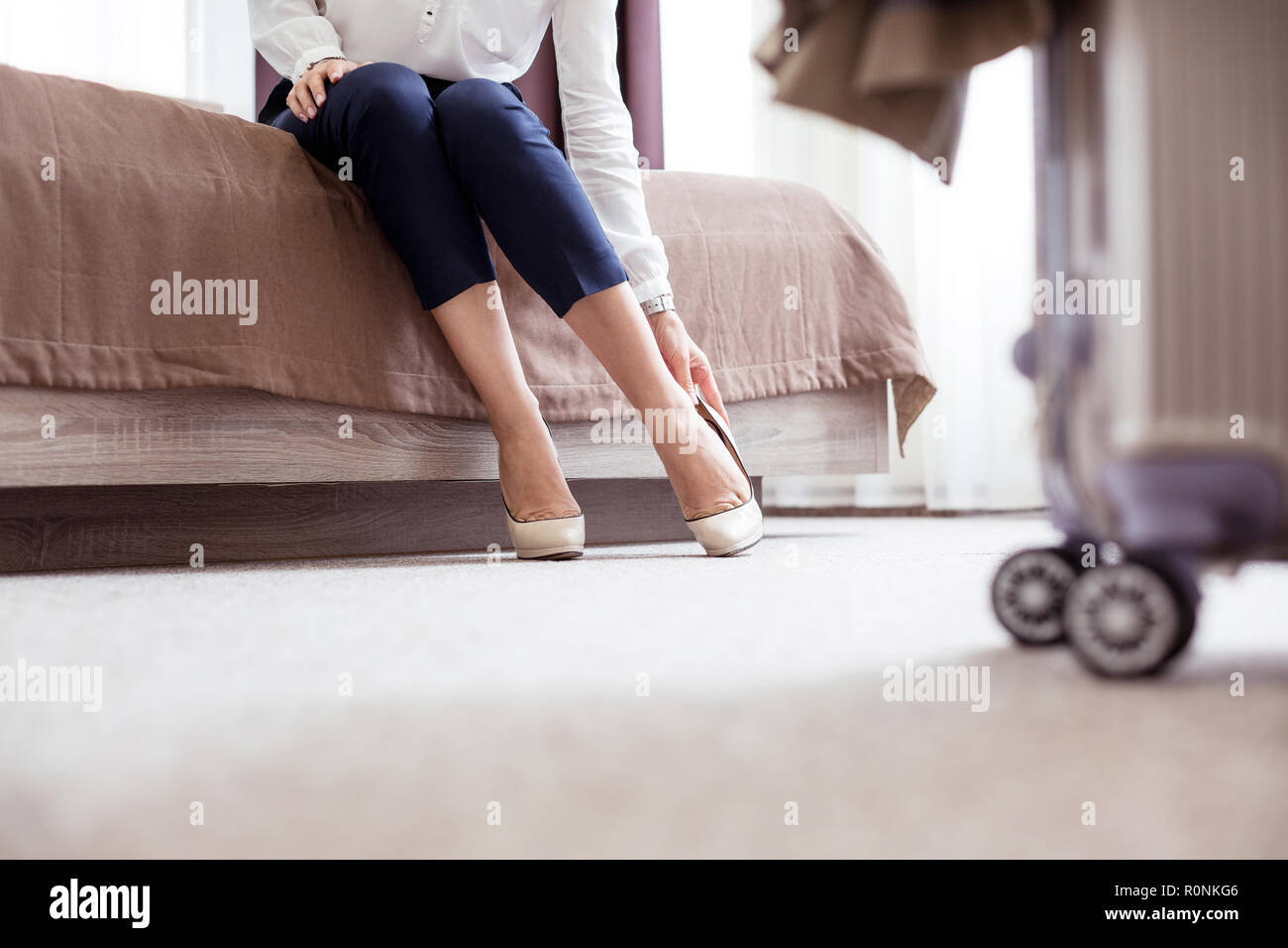 Business woman taking off shoes hi-res stock photography and images - Alamy