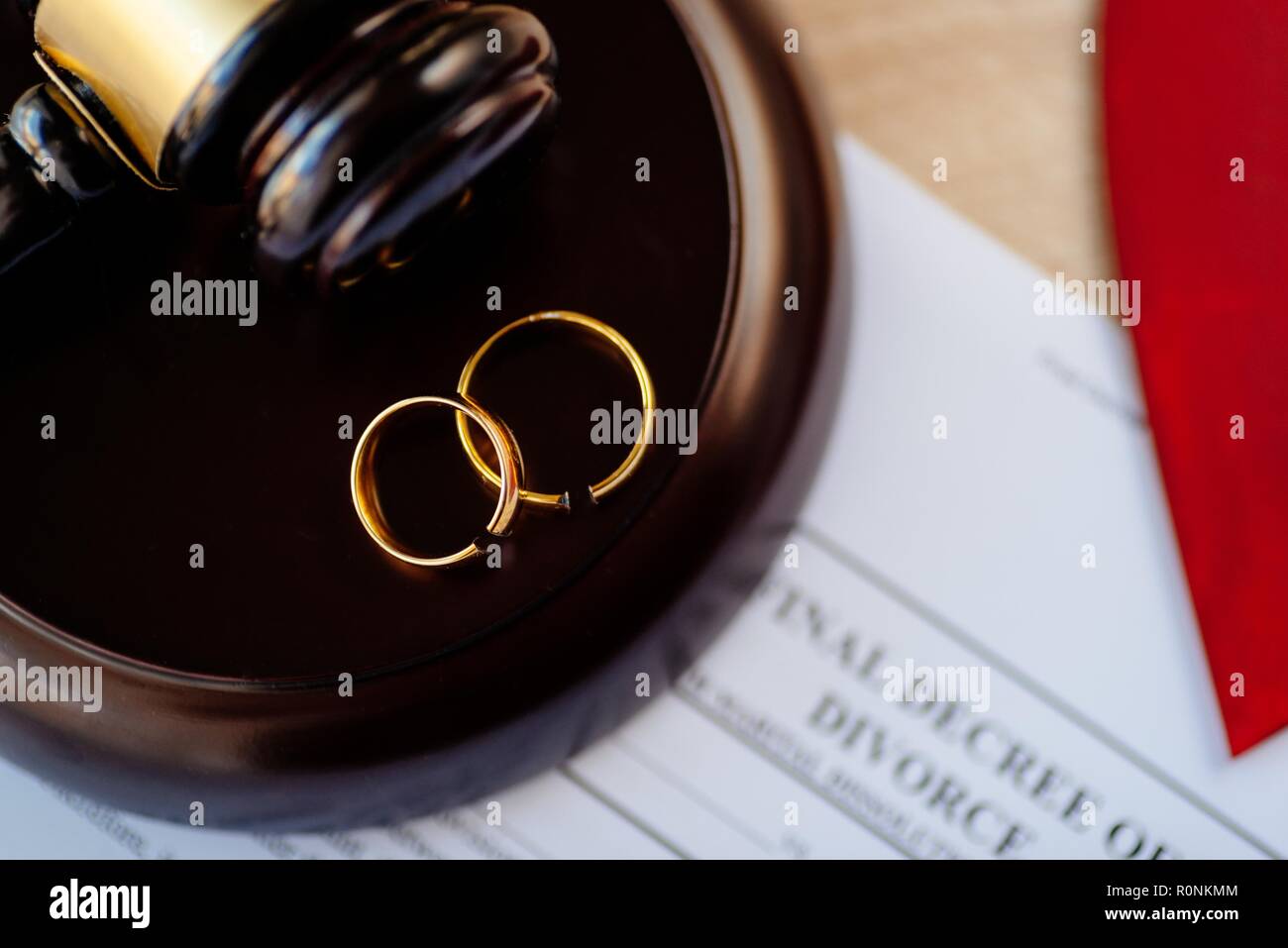 Two broken golden wedding rings on judge gavel. Divorce and separation ...