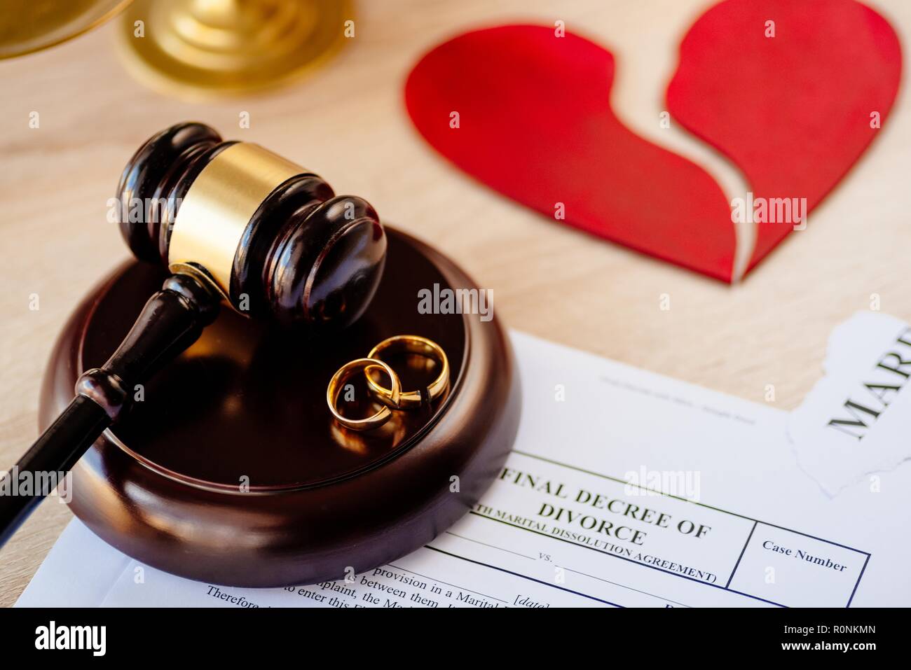 Two broken golden wedding rings on judge gavel. Divorce and separation ...