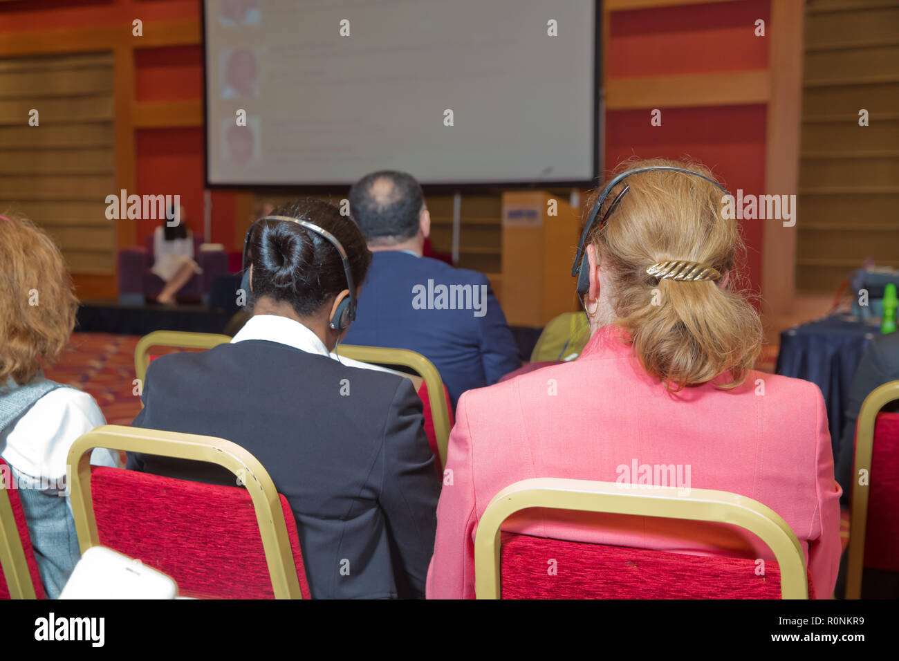 bald security guard with the headset to control people . heated debate ...