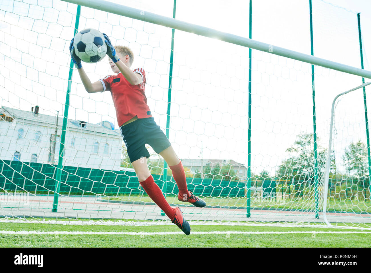 Boy Catching Ball Stock Photo - Alamy