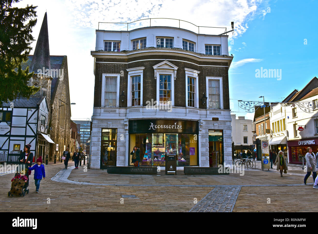 Early morning shoppers pass the impressive building occupied by ...