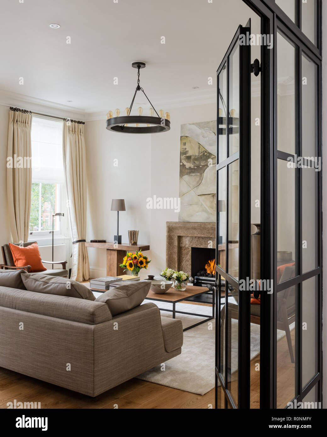 Living room with lit fire Stock Photo - Alamy