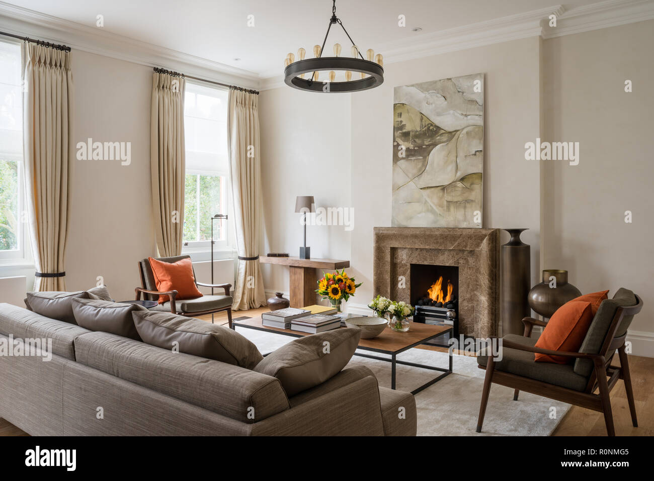 Living room with lit fire Stock Photo - Alamy
