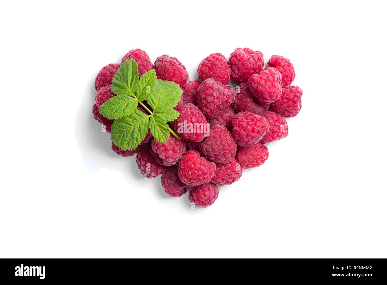 Heart shaped raspberries on white background Stock Photo - Alamy