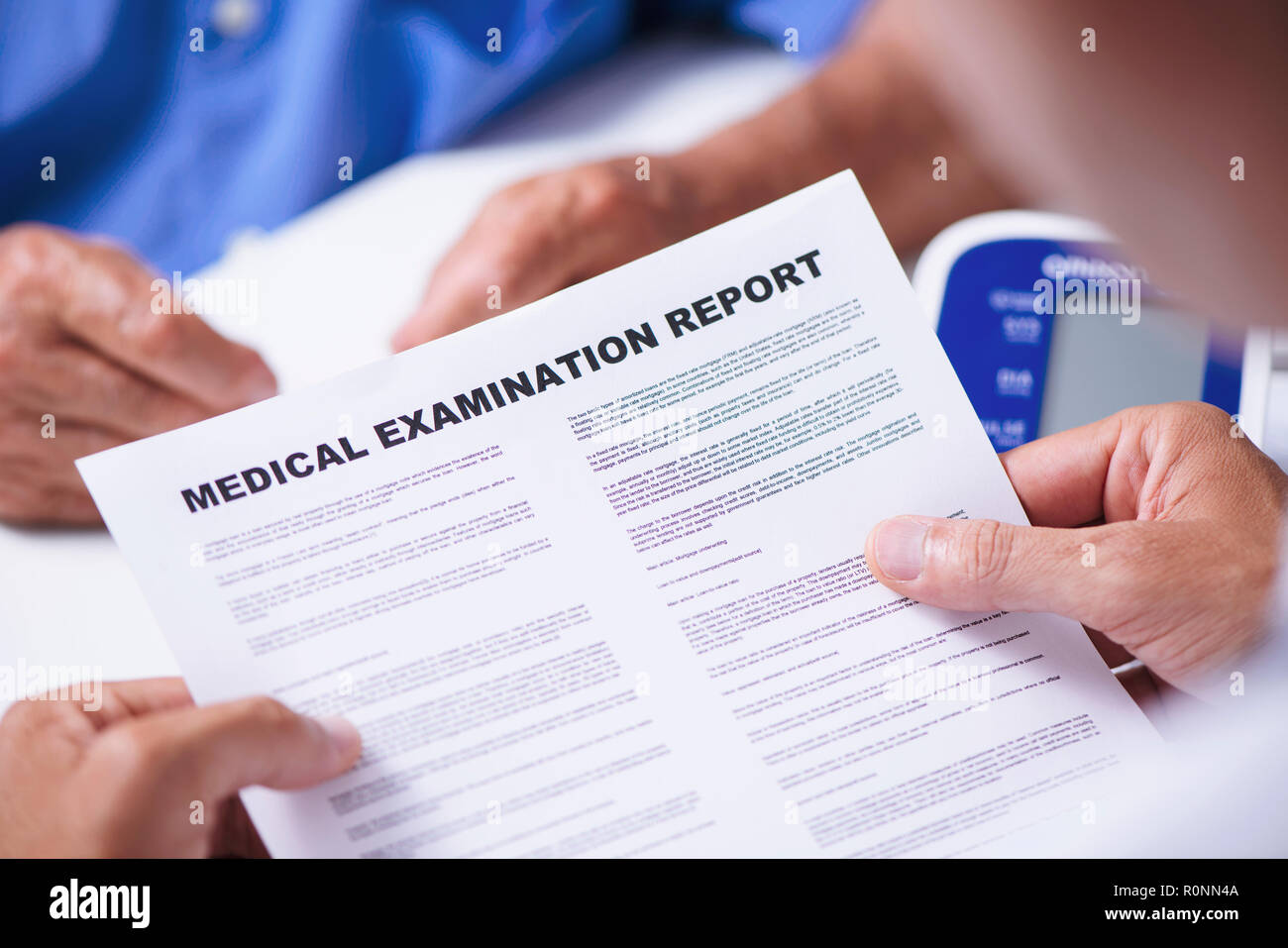 closeup of a caucasian doctor man reading a medical examination report ...