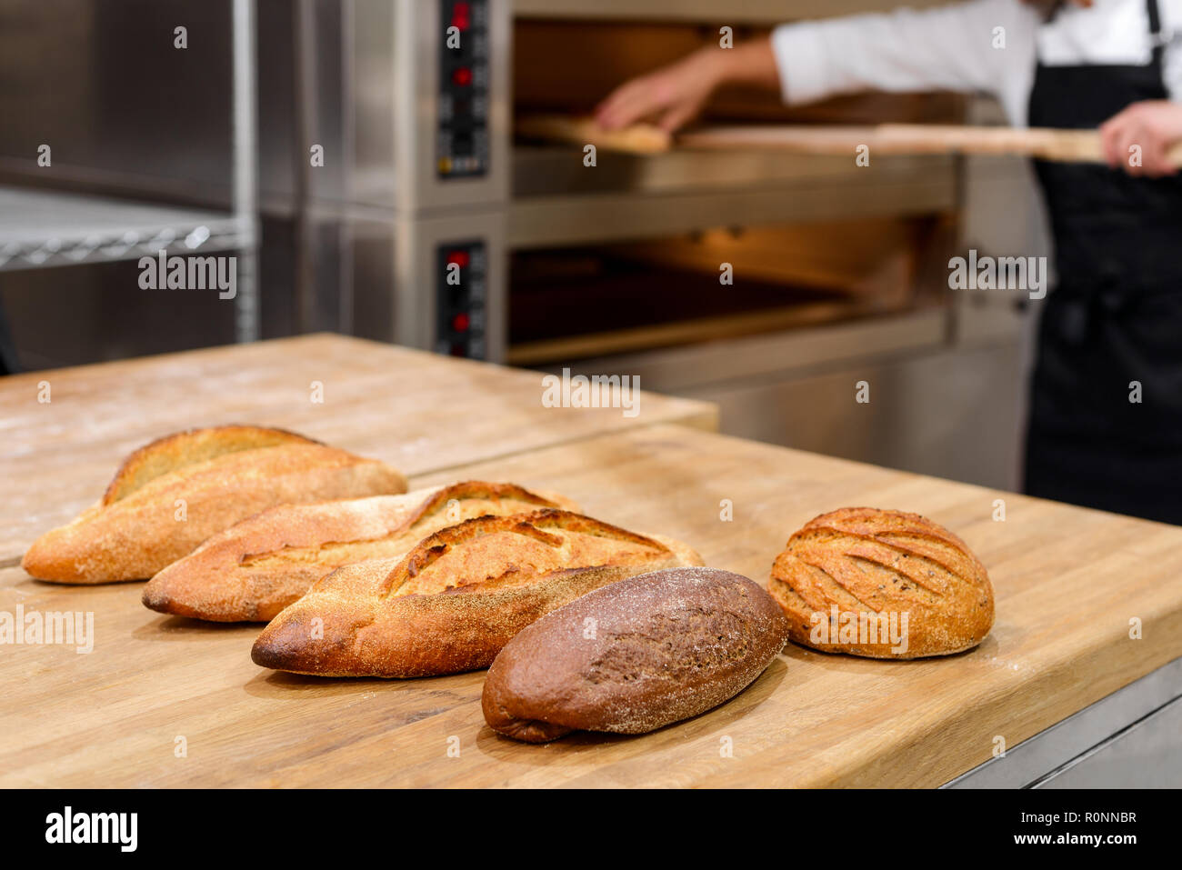 Baker getting fresh bread hi-res stock photography and images - Alamy