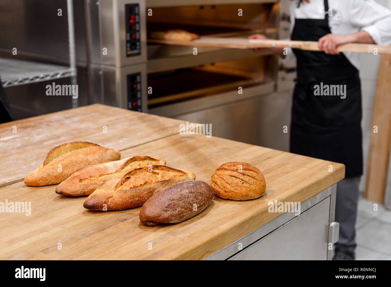 Taking baked bread out Stock Photo - Alamy