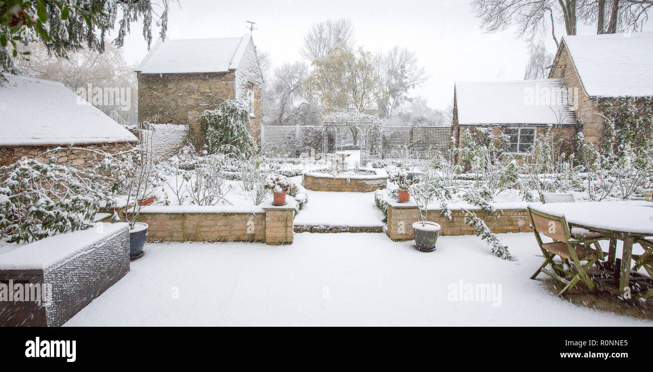 A garden view in the snow,winter in the Cotswolds Worcestershire March ...