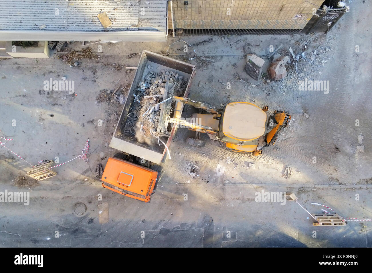 Bulldozer loader uploading waste and debris into dump truck at ...