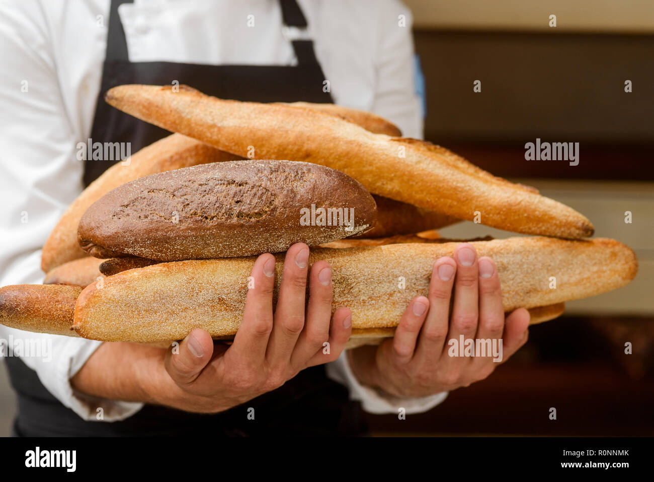Baker carrying fresh bread Stock Photo - Alamy