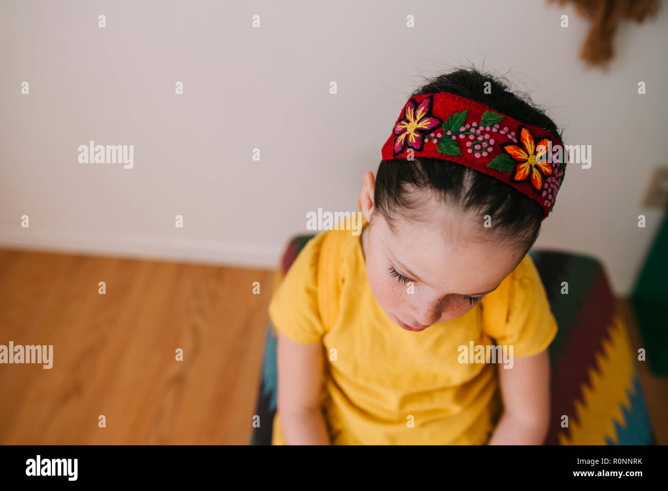 Overhead view of a girl sitting on a stool Stock Photo - Alamy