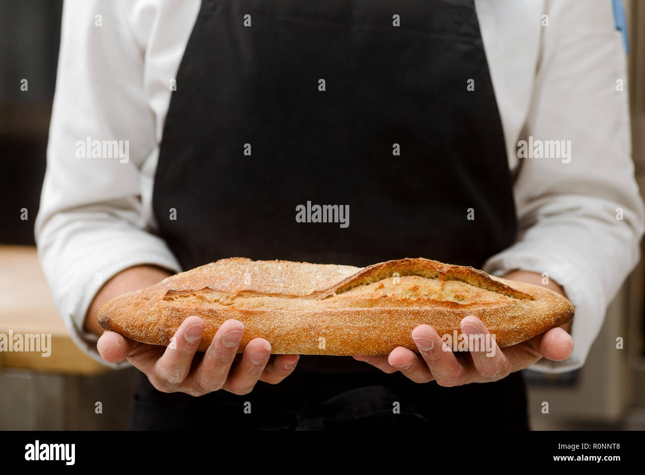 Baker demonstating his fresh bread Stock Photo - Alamy