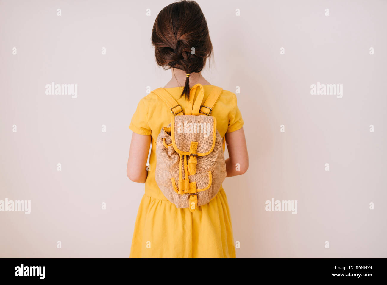 Rear view of a girl wearing a backpack Stock Photo - Alamy