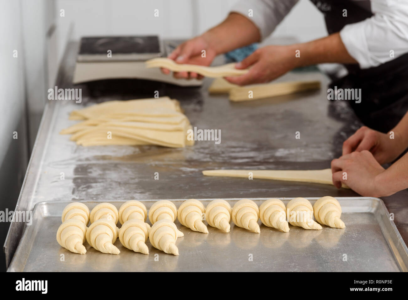 Bakery workers making crescent rolls Stock Photo - Alamy