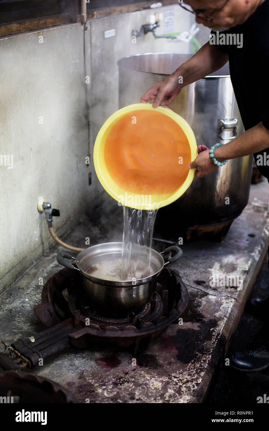 Man pouring bucket water hi-res stock photography and images - Alamy