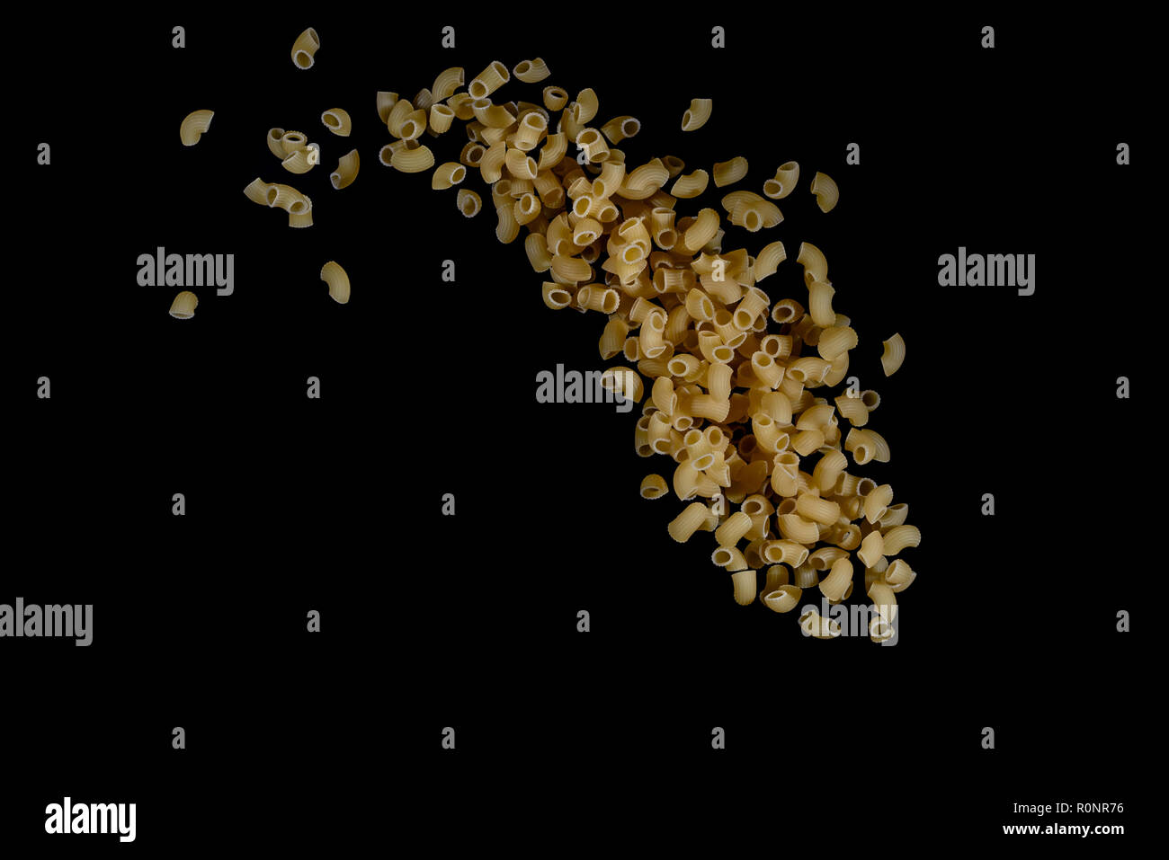 Flying pasta isolated on black background. Abstract macaroni falling ...