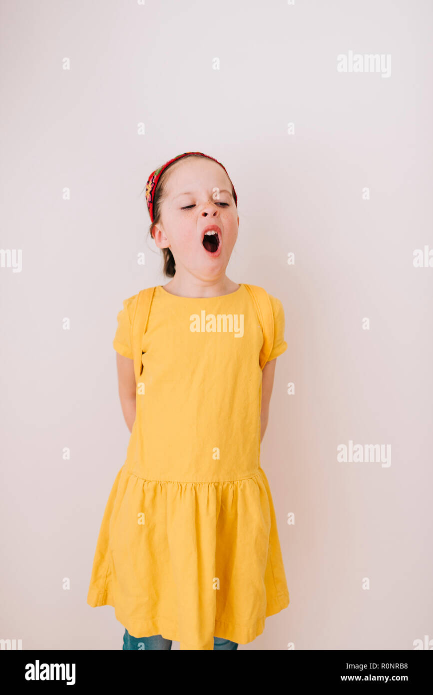 Portrait of a girl yawning Stock Photo - Alamy