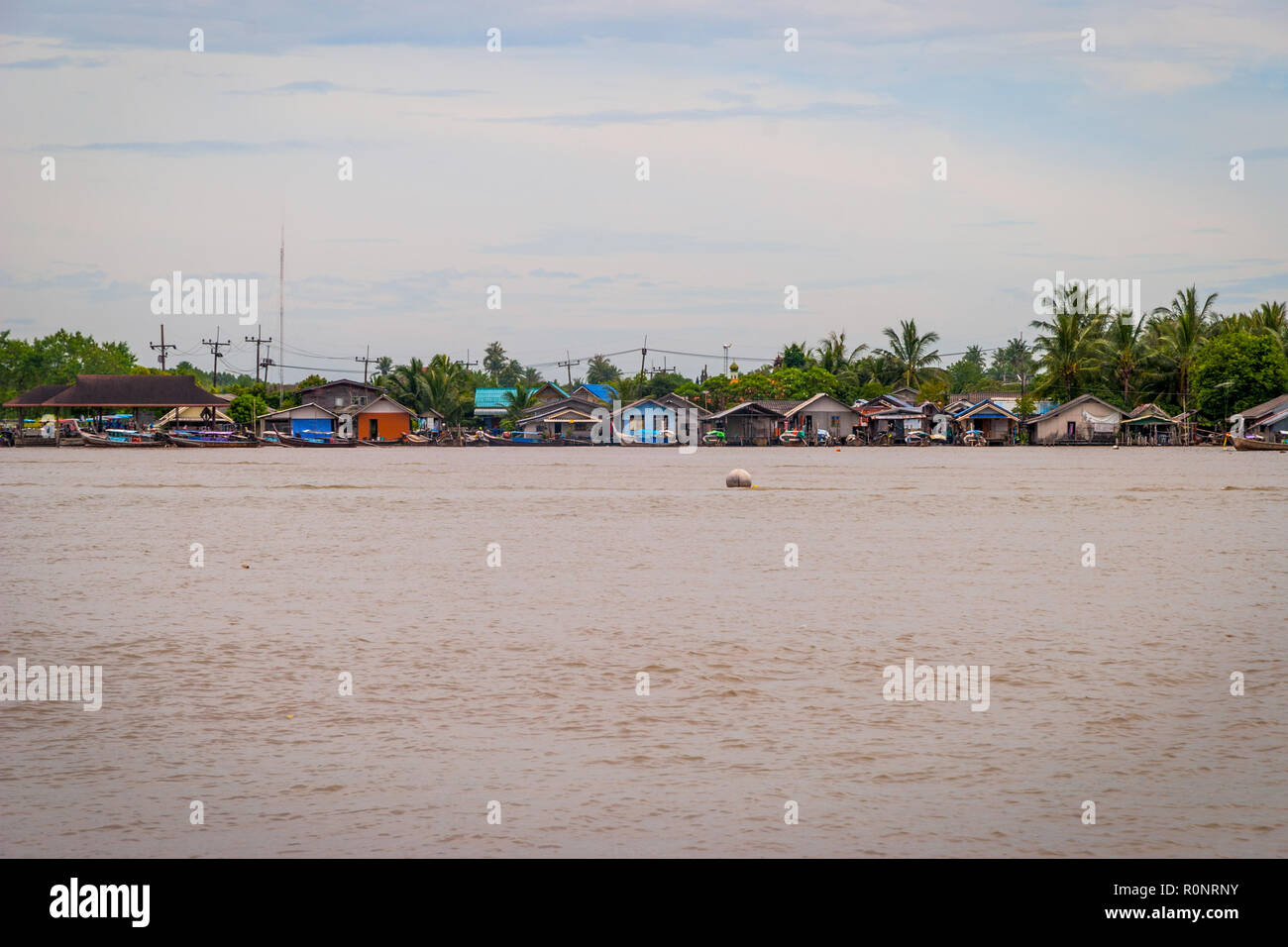 View over the Krabi river with fishing boats and local houses on the ...