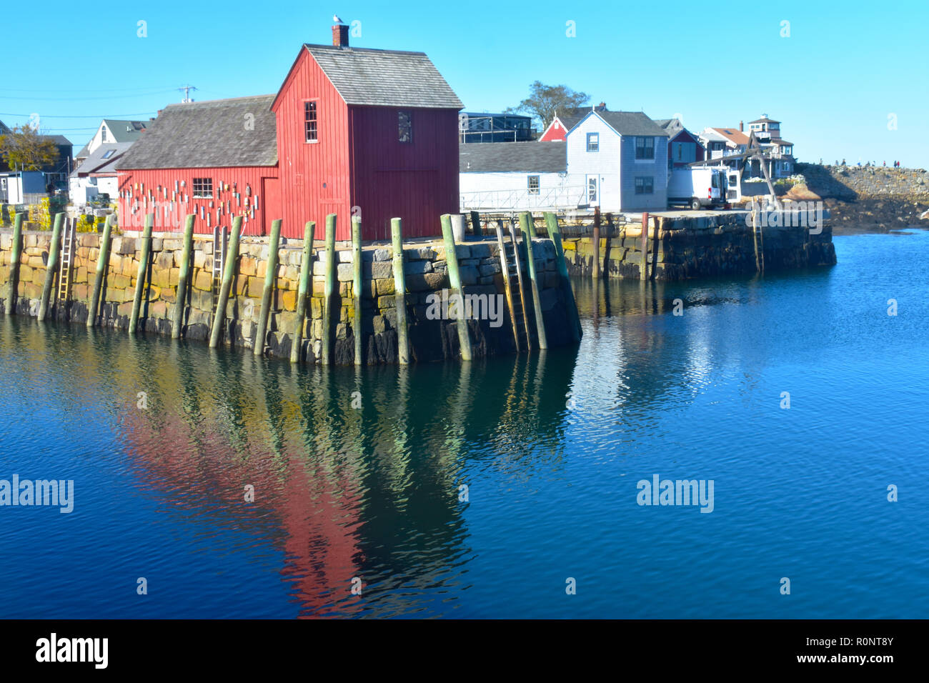 Motif No 1 with its reflection in Rockport Harbor waters. This red ...