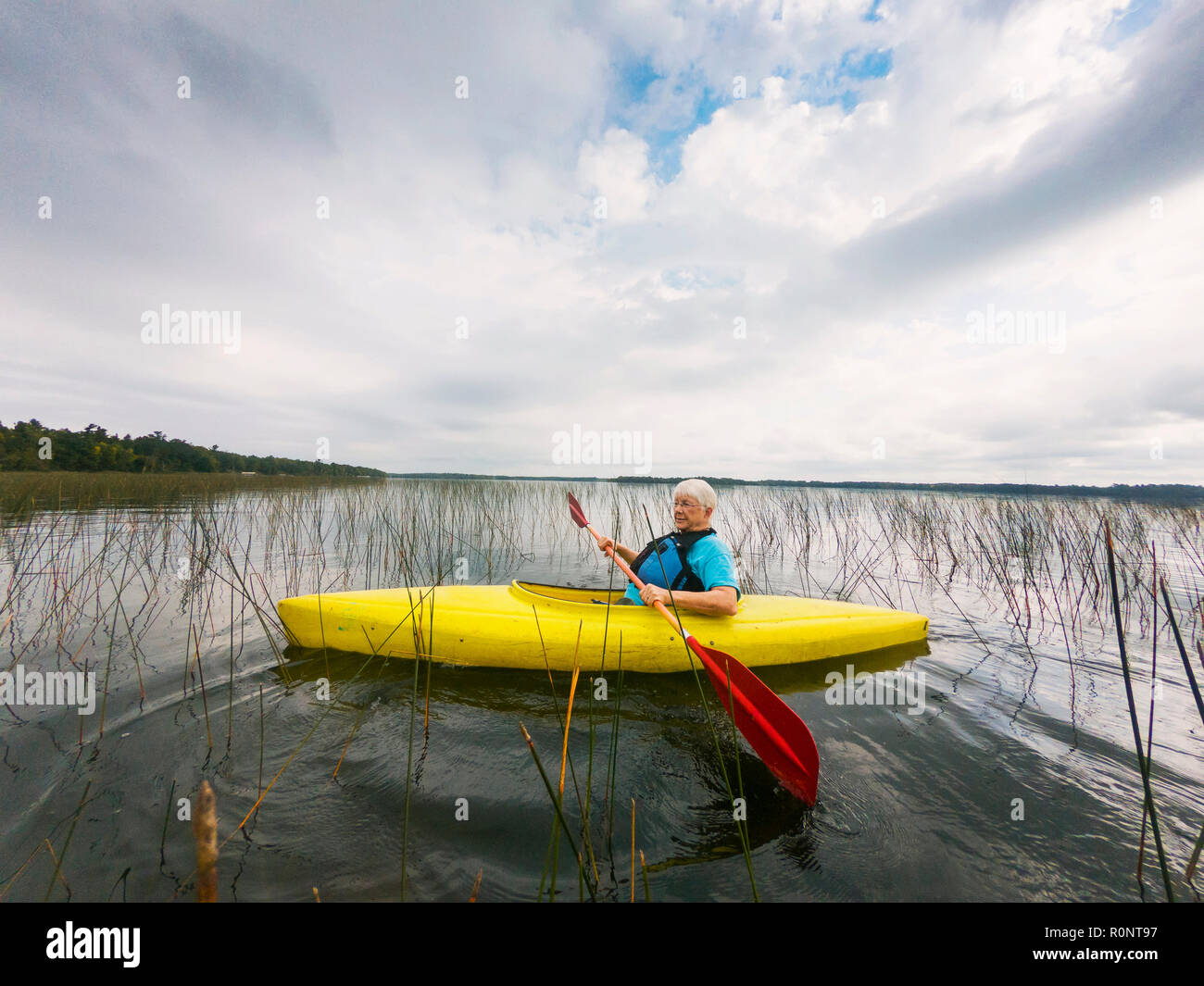 Senior woman kayaking on a lake, United States Stock Photo - Alamy