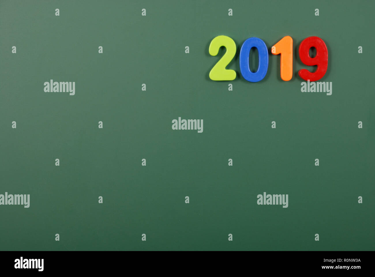 2019 year written in bright plastic magnetic letters stuck on a ...