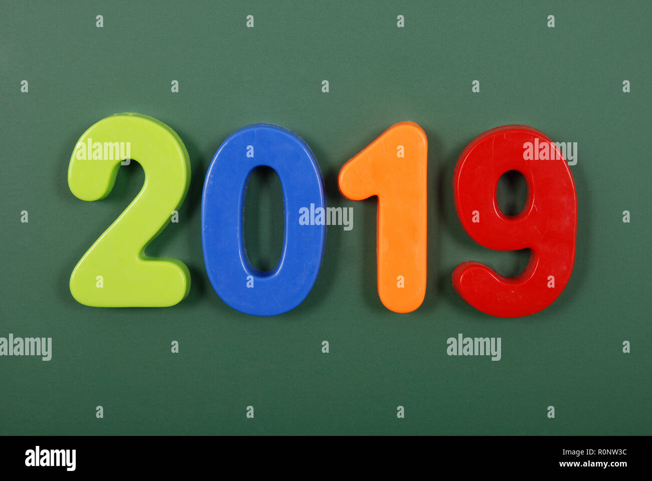 2019 year written in bright plastic magnetic letters stuck on a ...