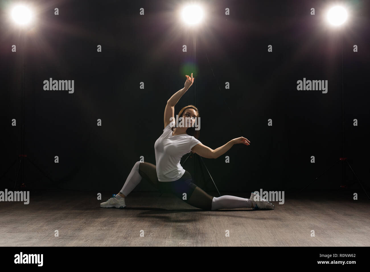 People and dancing concept - Pretty woman dancing jazz funk over dark ...