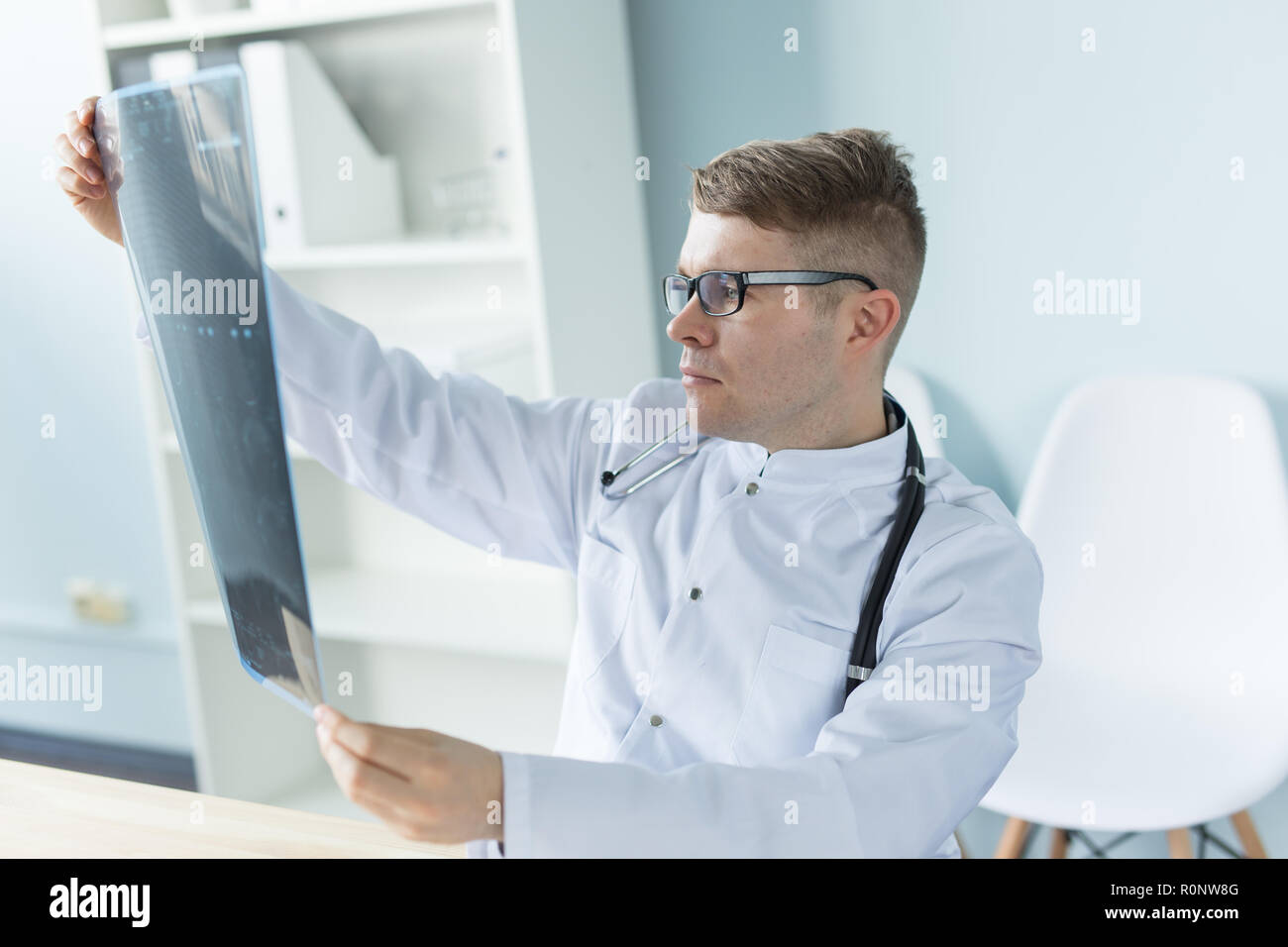 Healthcare, medical and people concept - doctor examines an x-ray ...