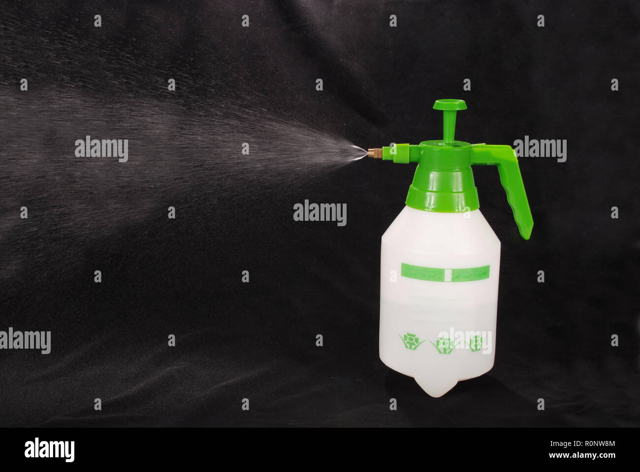 Pressure sprayer bottle. Isolated on black background Stock Photo - Alamy
