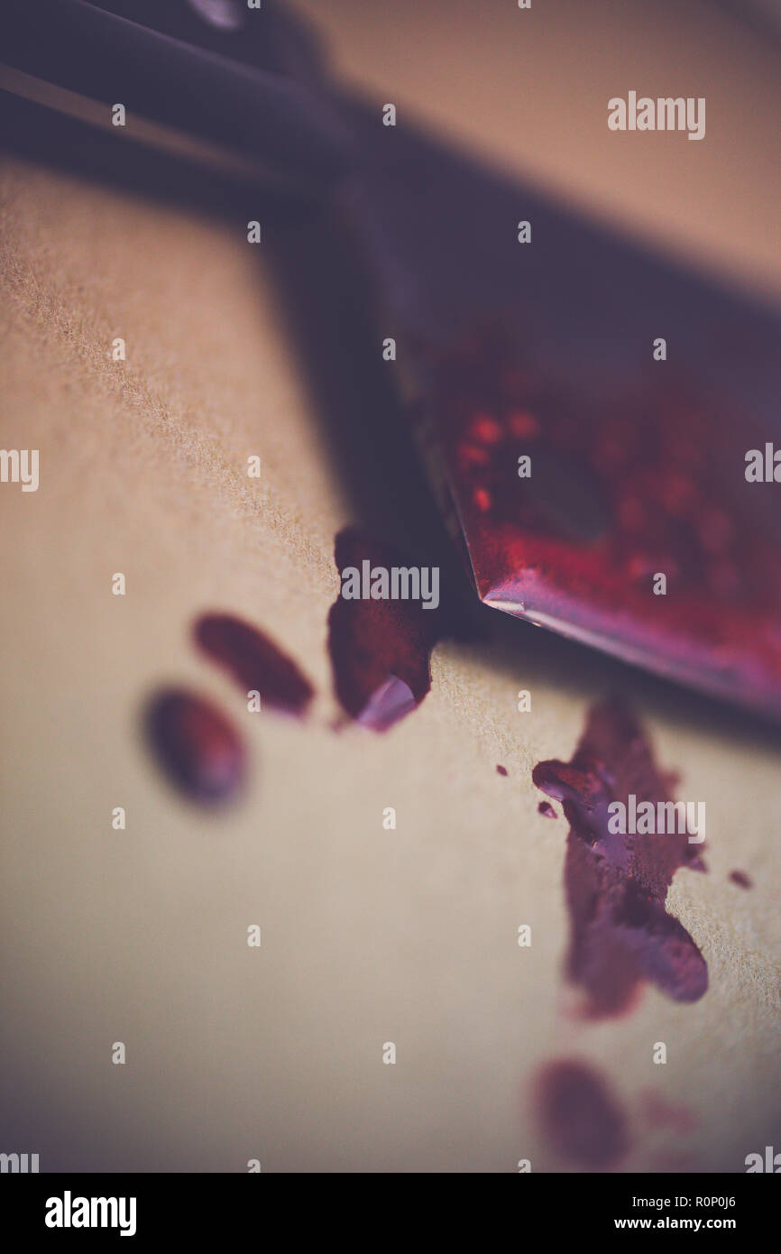 A bloody meat cleaver atop a brown surface Stock Photo - Alamy