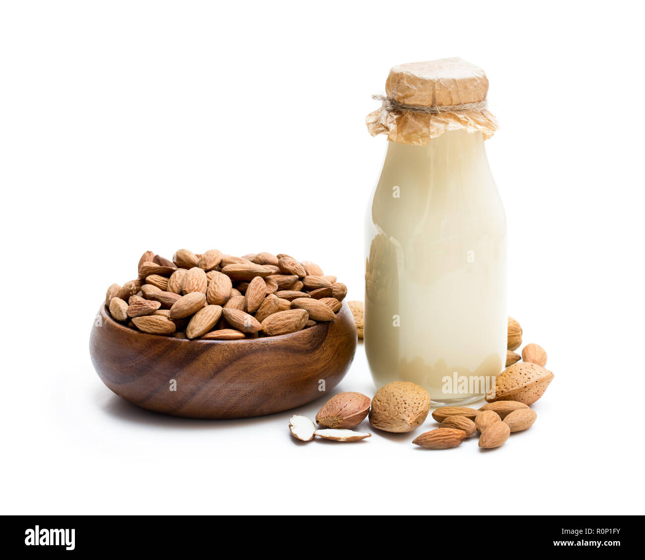 Almond milk in glass bottle isolated on white Stock Photo - Alamy