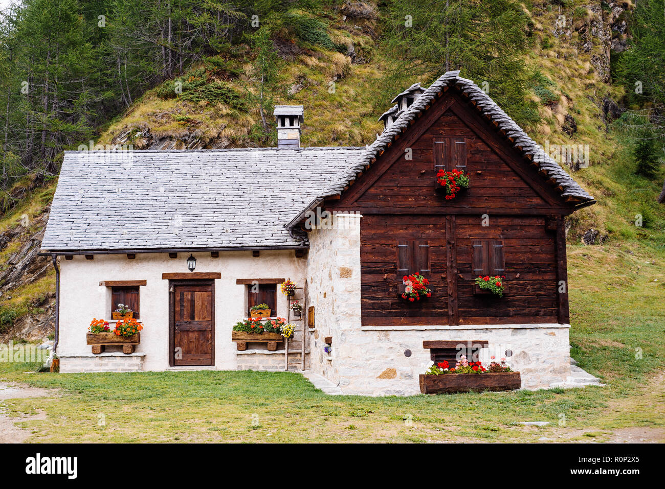 mountain house with flowers on the windows in the nature,Alpe Devero ...