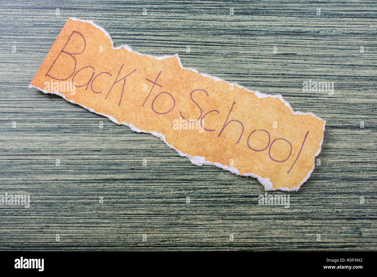 Back to school wording on a piece of torn paper Stock Photo - Alamy