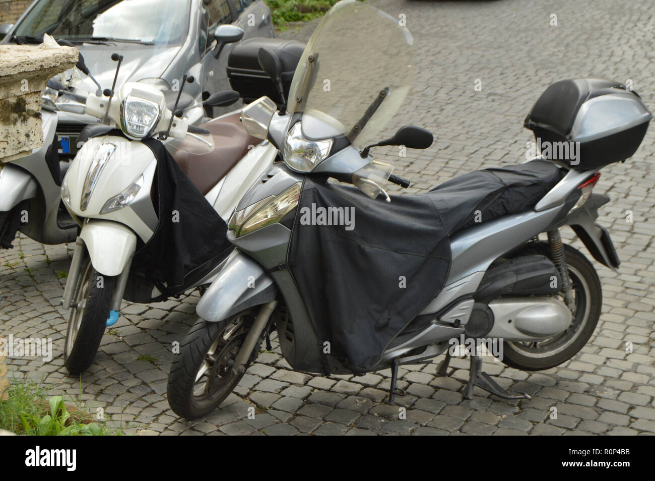 Two black motorcycles are parked on the street in Rome, Italy Stock ...