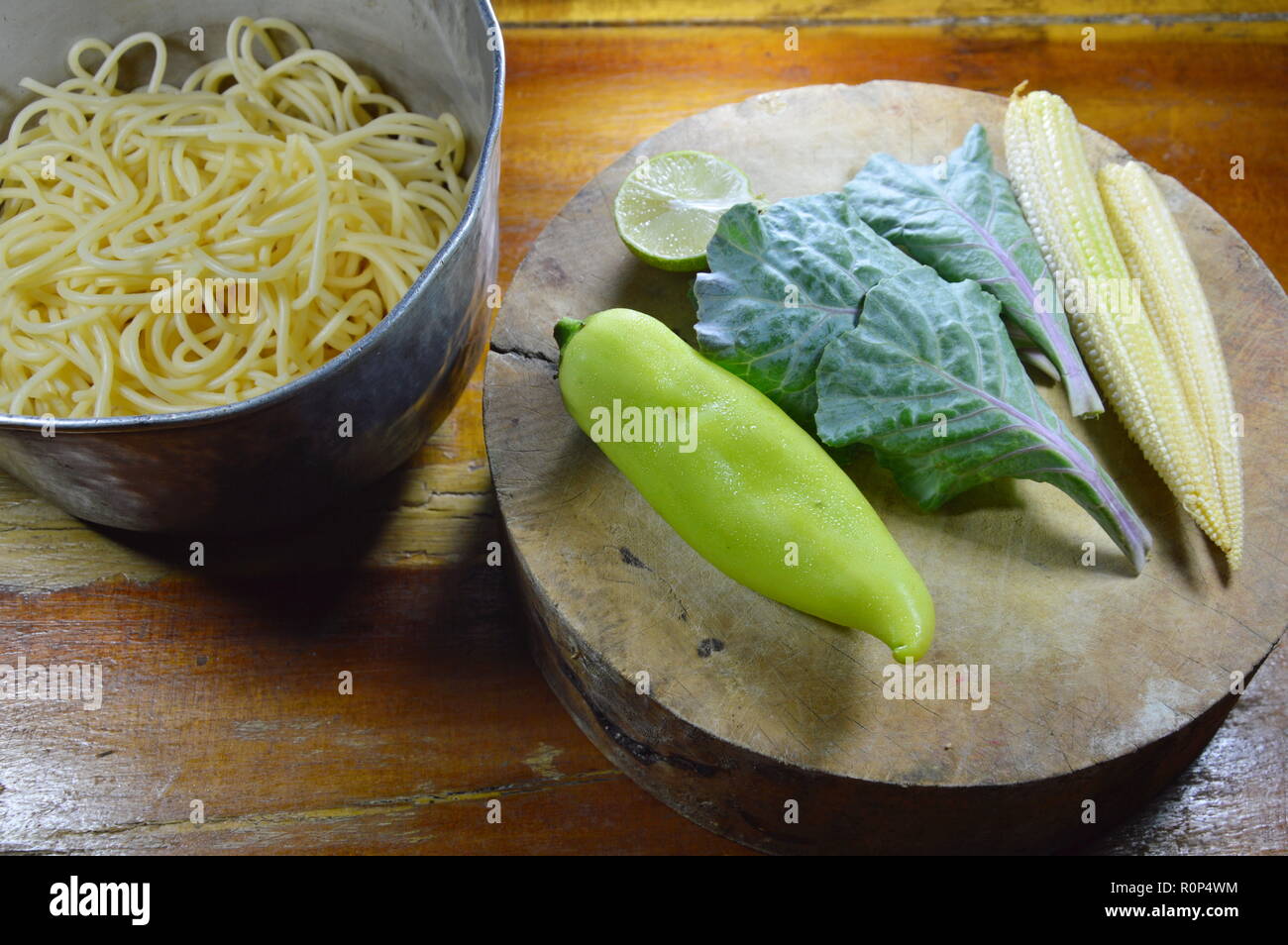 spaghetti in iron pot and vegetable on circle chop block Stock Photo ...